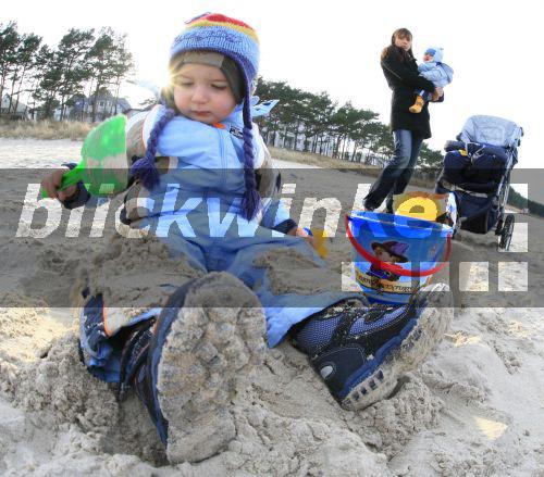 blickwinkel - kleiner Junge spielt im Winter am Sandstrand, Deutschland ...